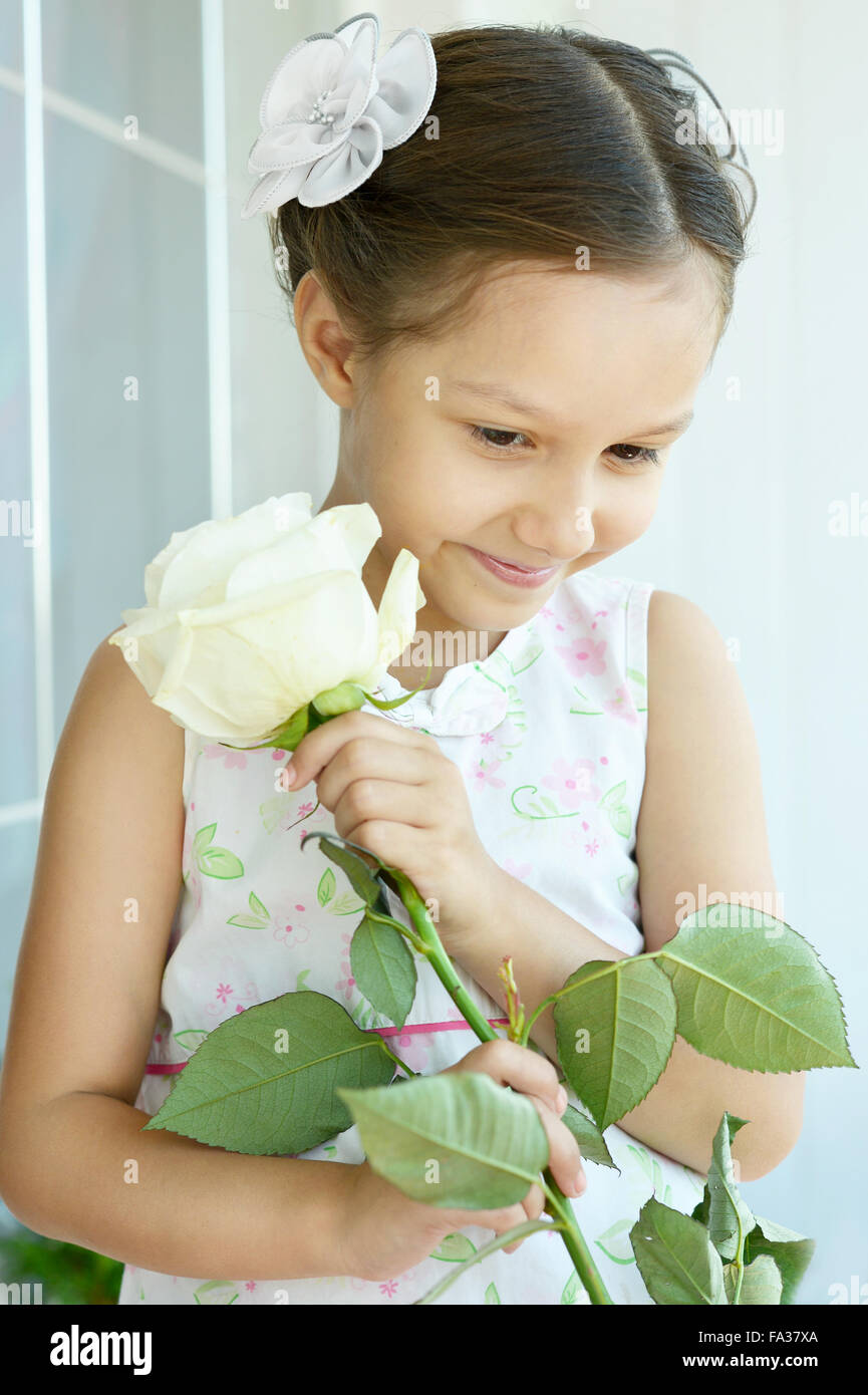 Little girl with rose flower Stock Photo - Alamy