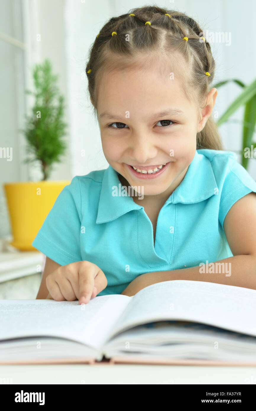 Beautiful little girl with book Stock Photo - Alamy