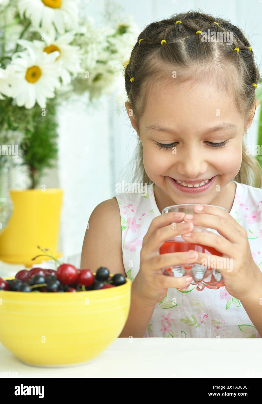 Cute Little girl eating cherries Stock Photo - Alamy