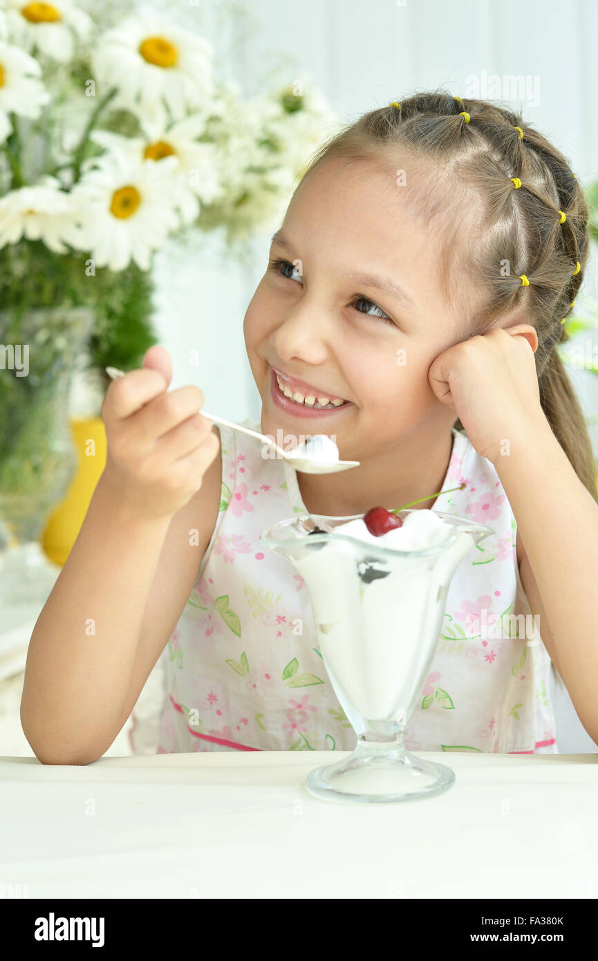 Girl eating sweet dessert with berries Stock Photo - Alamy
