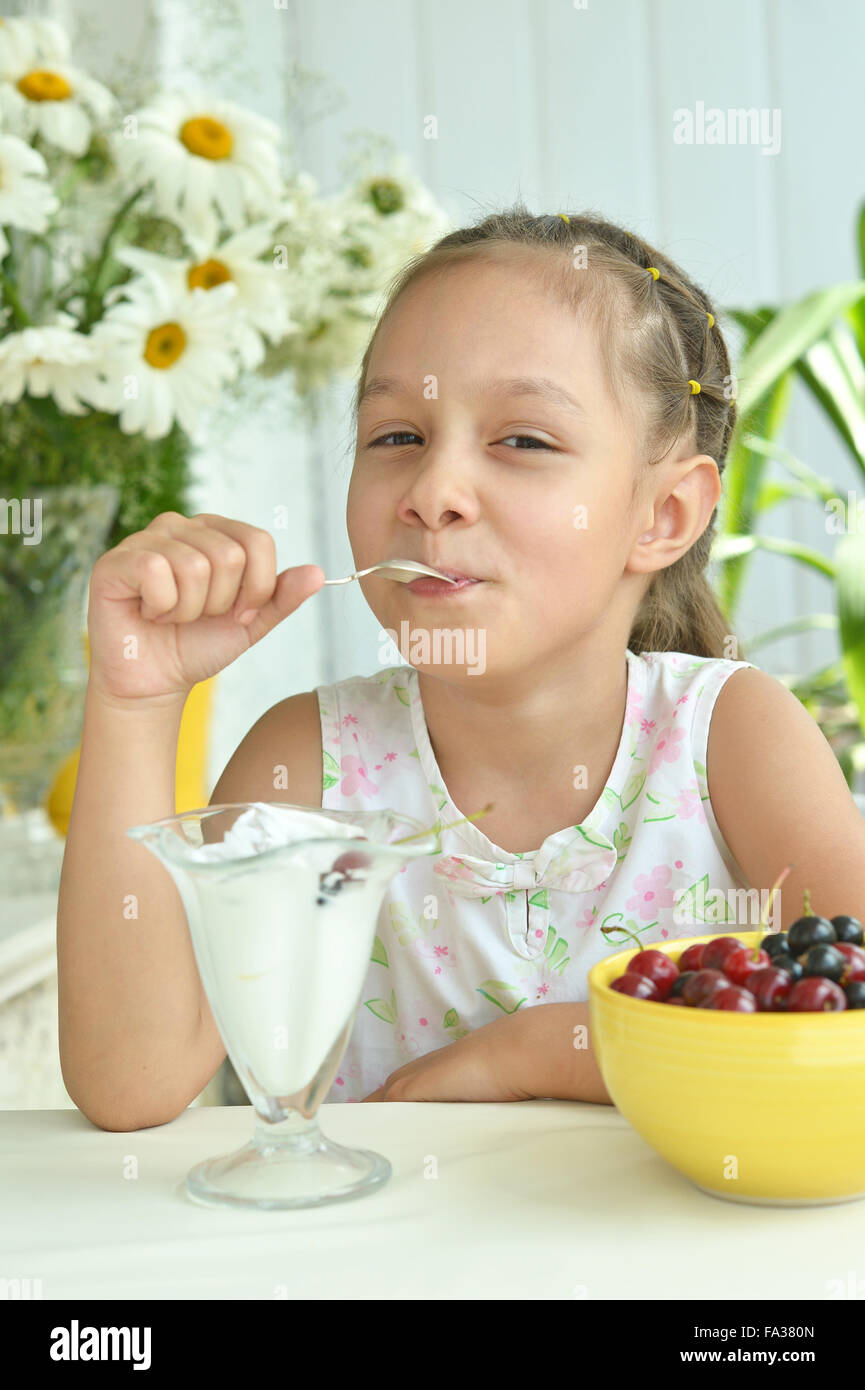 Girl eating sweet dessert with berries Stock Photo - Alamy