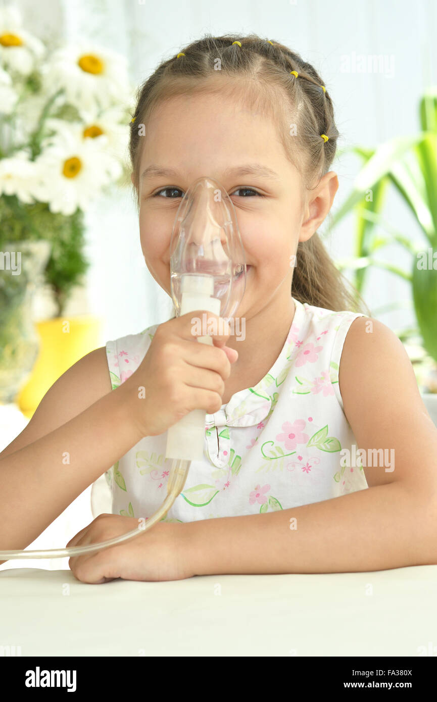 Little girl with mask for inhalation Stock Photo - Alamy