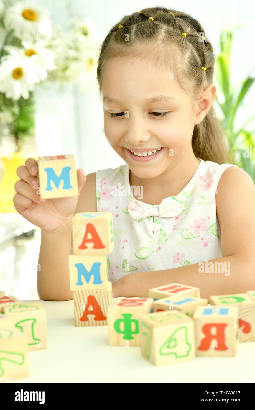 Little girl playing with cubes Stock Photo - Alamy
