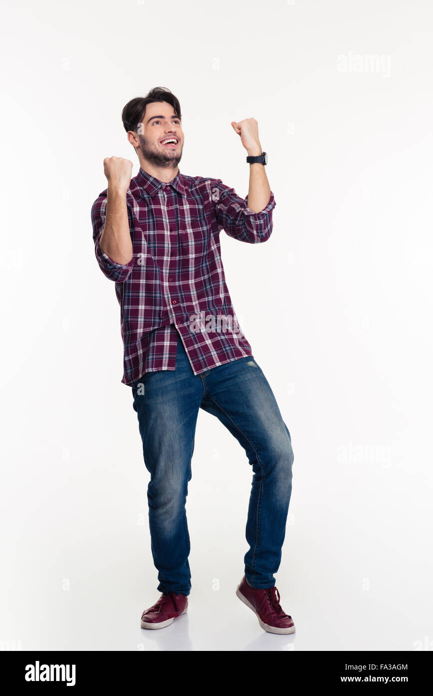 Full length portrait of a casual man celebrating his success isolated ...