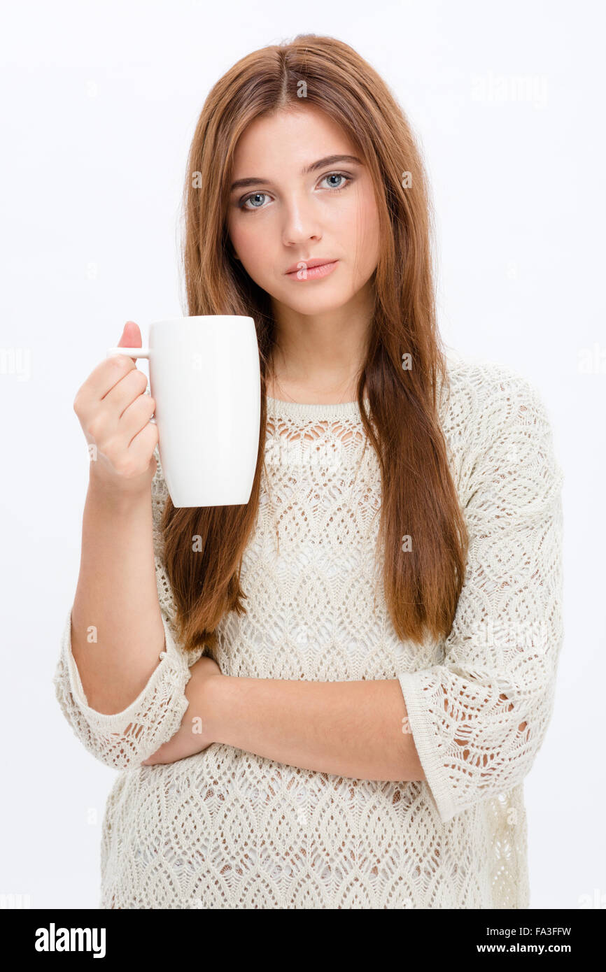 Lovely cute young woman in white clothes drinking tea over white ...