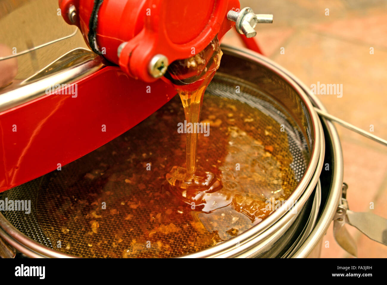 Extracting honey from the frames in a bee hive with the extractor tap ...