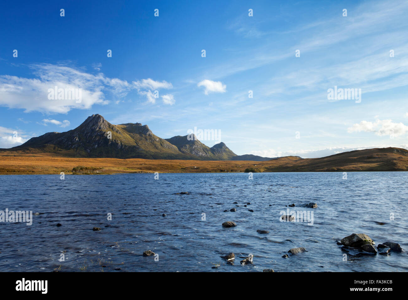 The mountain range of Ben Loyal with the loch below, in late afternoon ...