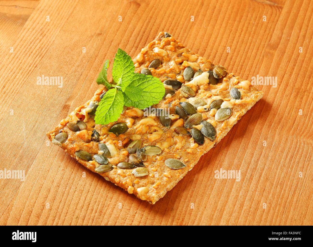 Whole grain cracker with cheddar and pepitas Stock Photo - Alamy