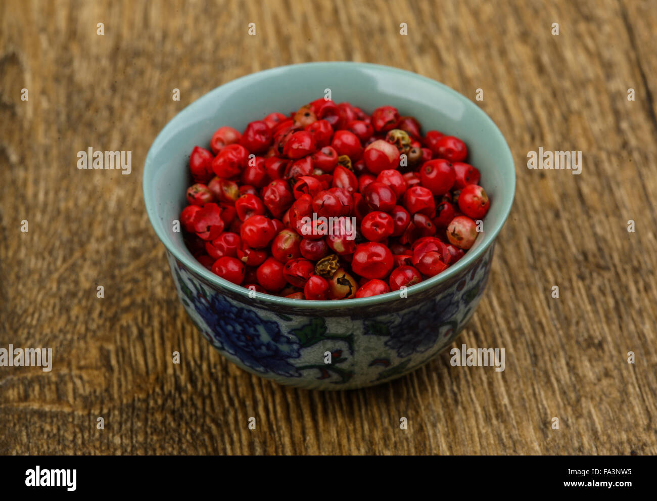 Dry Rose pepper corn on the wood background Stock Photo - Alamy