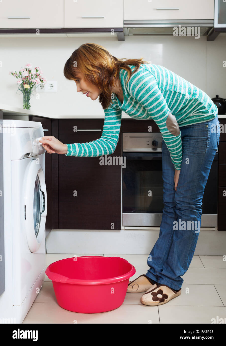 woman doing laundry with washing machine Stock Photo - Alamy