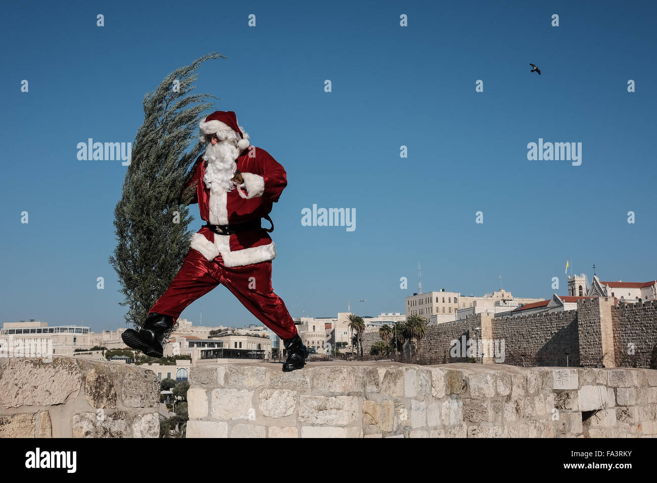 Jerusalem, Israel. 21st December, 2015. Issa, in a Santa Claus costume ...