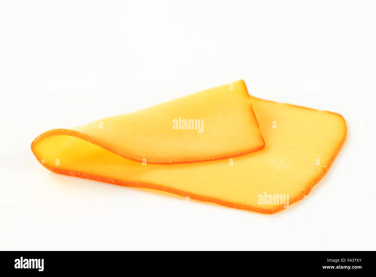 Thin slice of smoked yellow cheese Stock Photo - Alamy