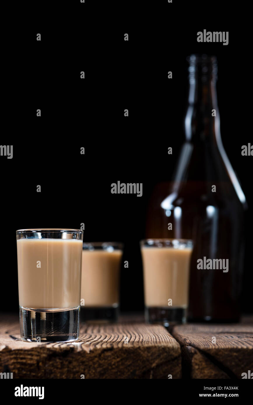 Glass with cold Cream Liqueur on vintage wooden background Stock Photo ...