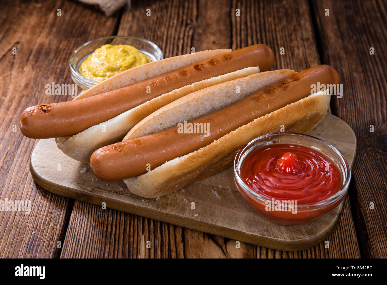 Pure Hot Dog with sauce on wooden background (close-up shot Stock Photo ...