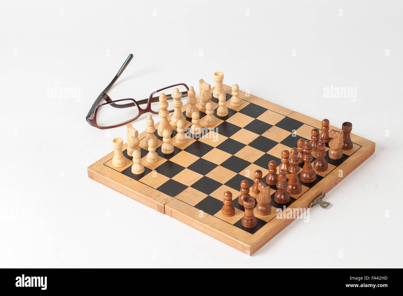 The chess game board in the photo with a white base and background with ...