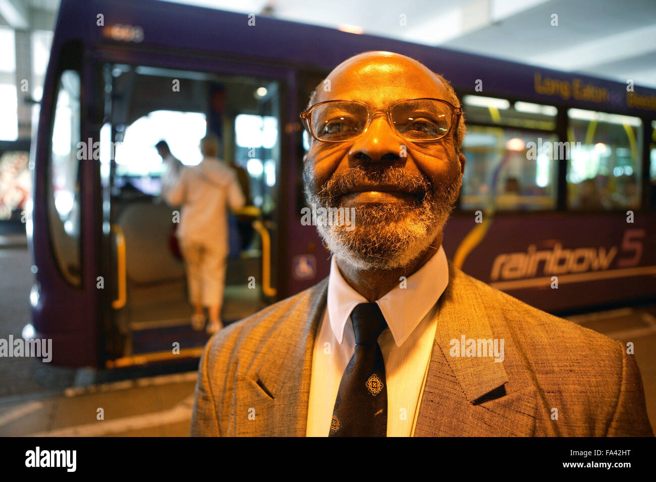 Man standing in front of a bus at the bus station Stock Photo - Alamy