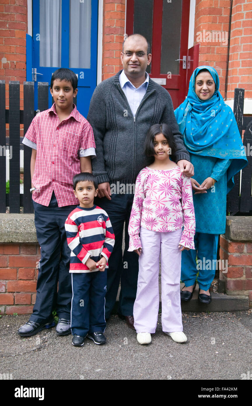 Young family standing outside the front door to their home Stock Photo ...