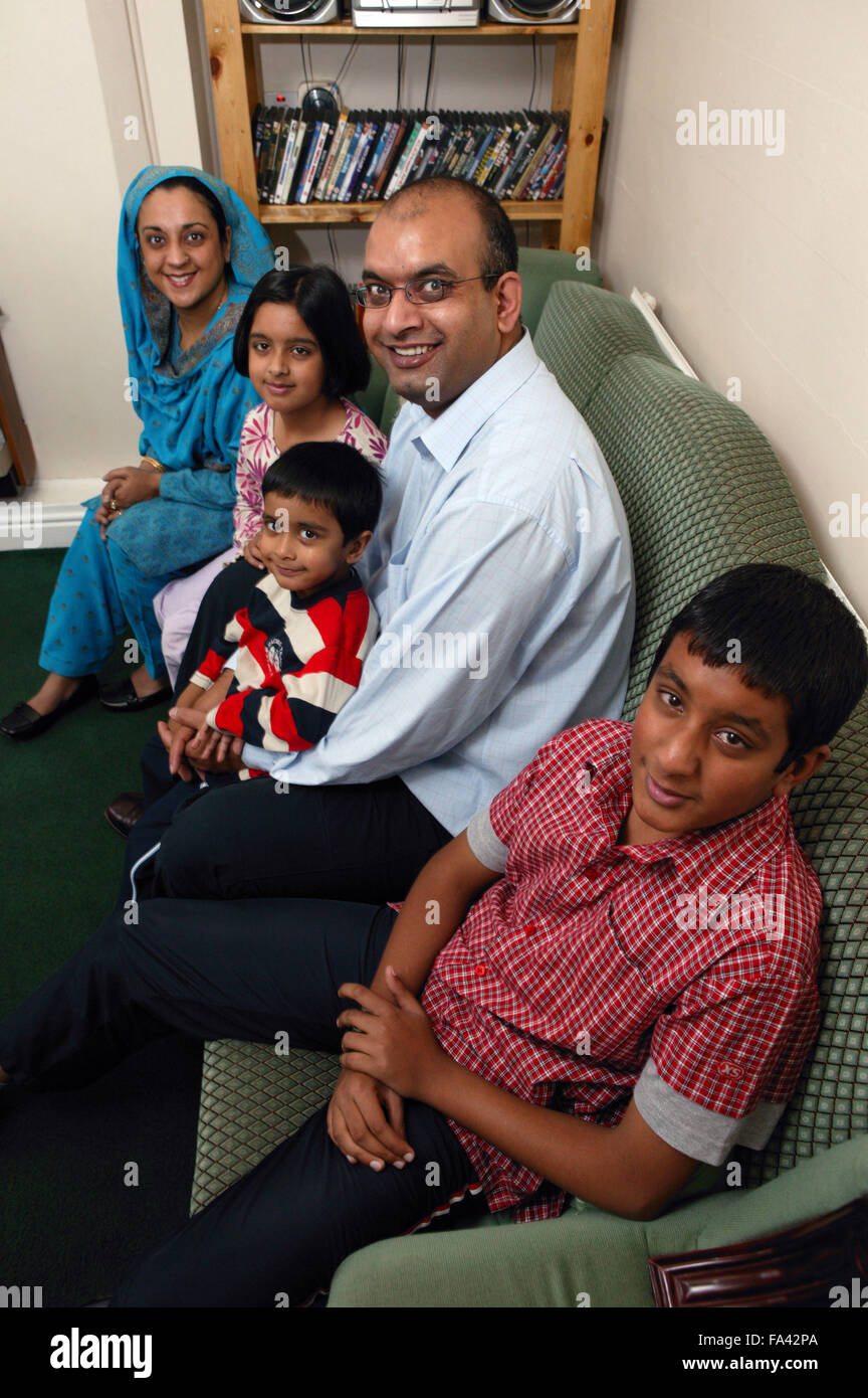 Family sitting on the sofa Stock Photo - Alamy
