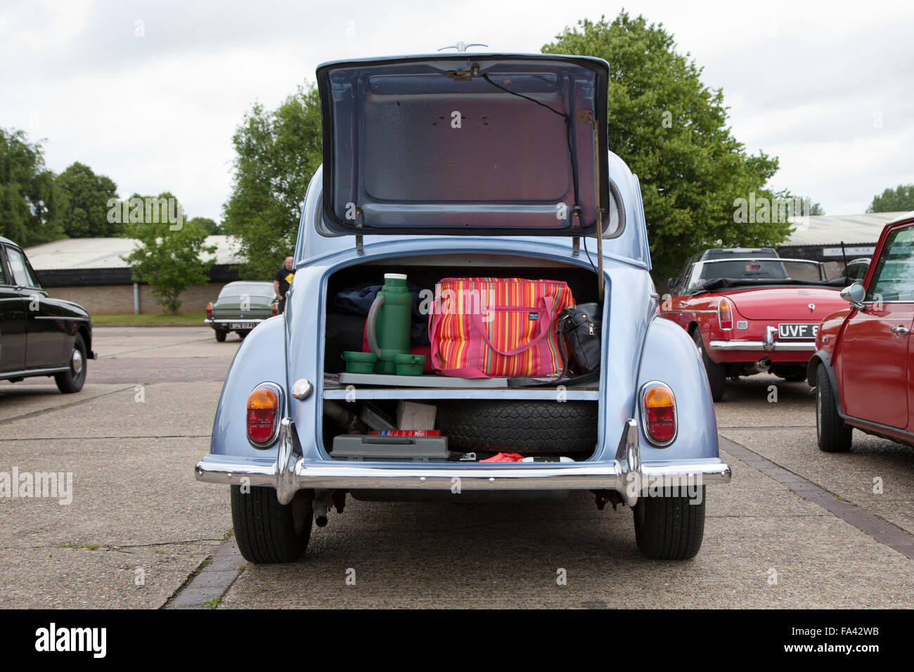 Classic Morris Minor 1000 displaying boot contents on a stopover during ...