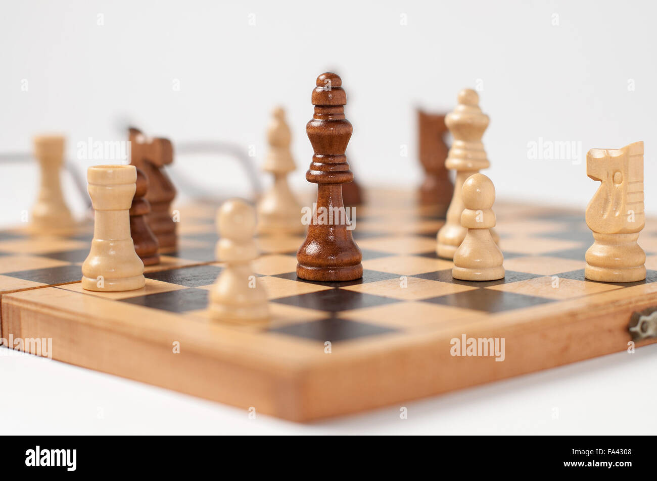 The chess game board in the photo with a white base and background with ...