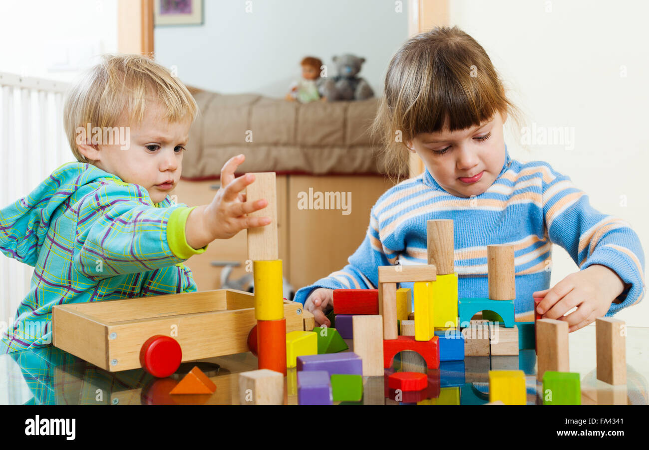 children with wooden blocks in home interior Stock Photo - Alamy