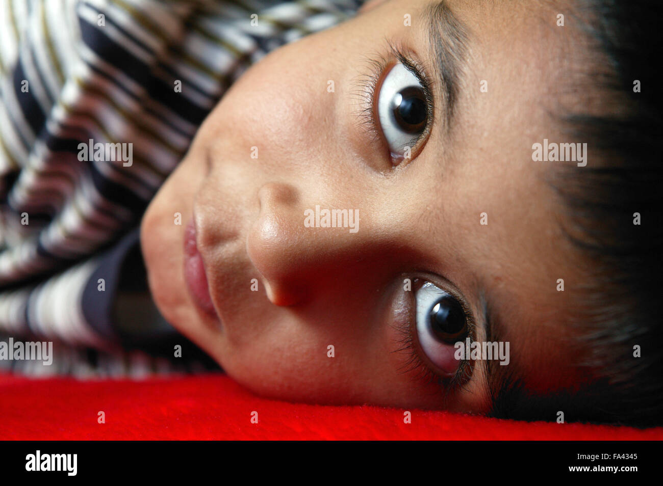 Portrait of young boy lying down Stock Photo - Alamy