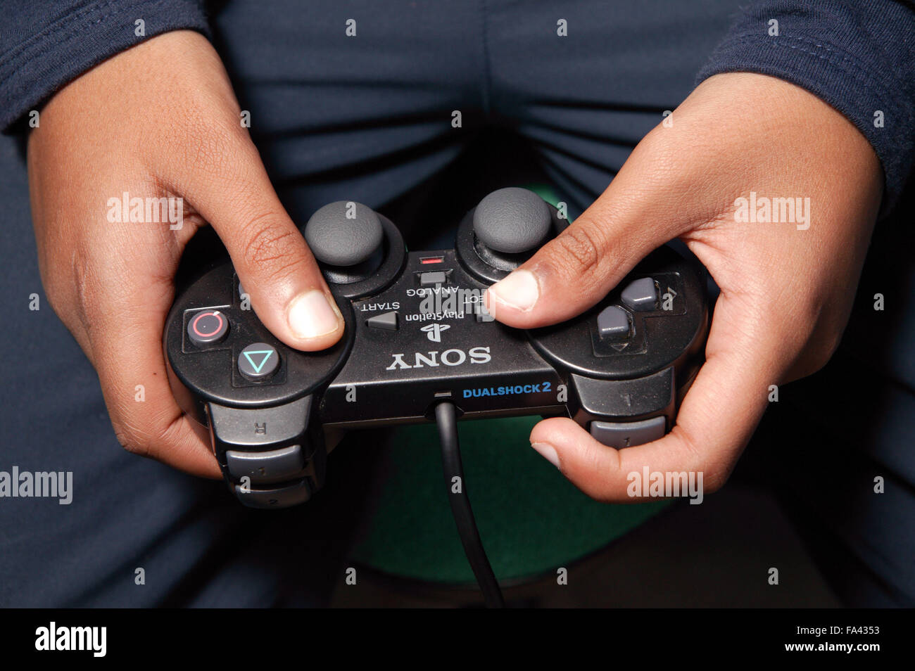 Close up of boys hands on playstation keypad Stock Photo - Alamy