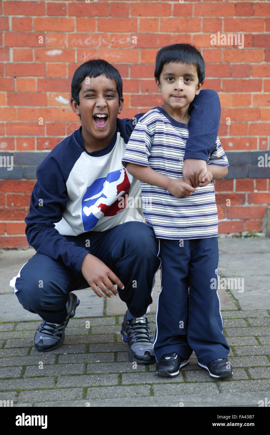 Portrait of two brothers standing in the street Stock Photo - Alamy