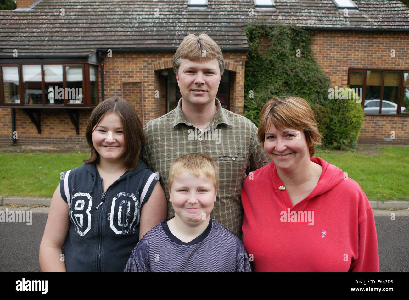 Family group standing outside their house Stock Photo - Alamy