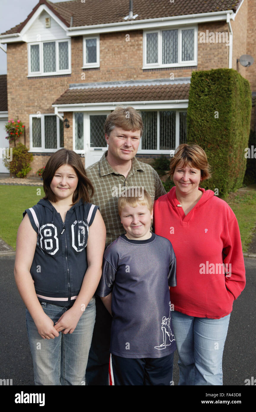 Family group standing outside their house Stock Photo - Alamy