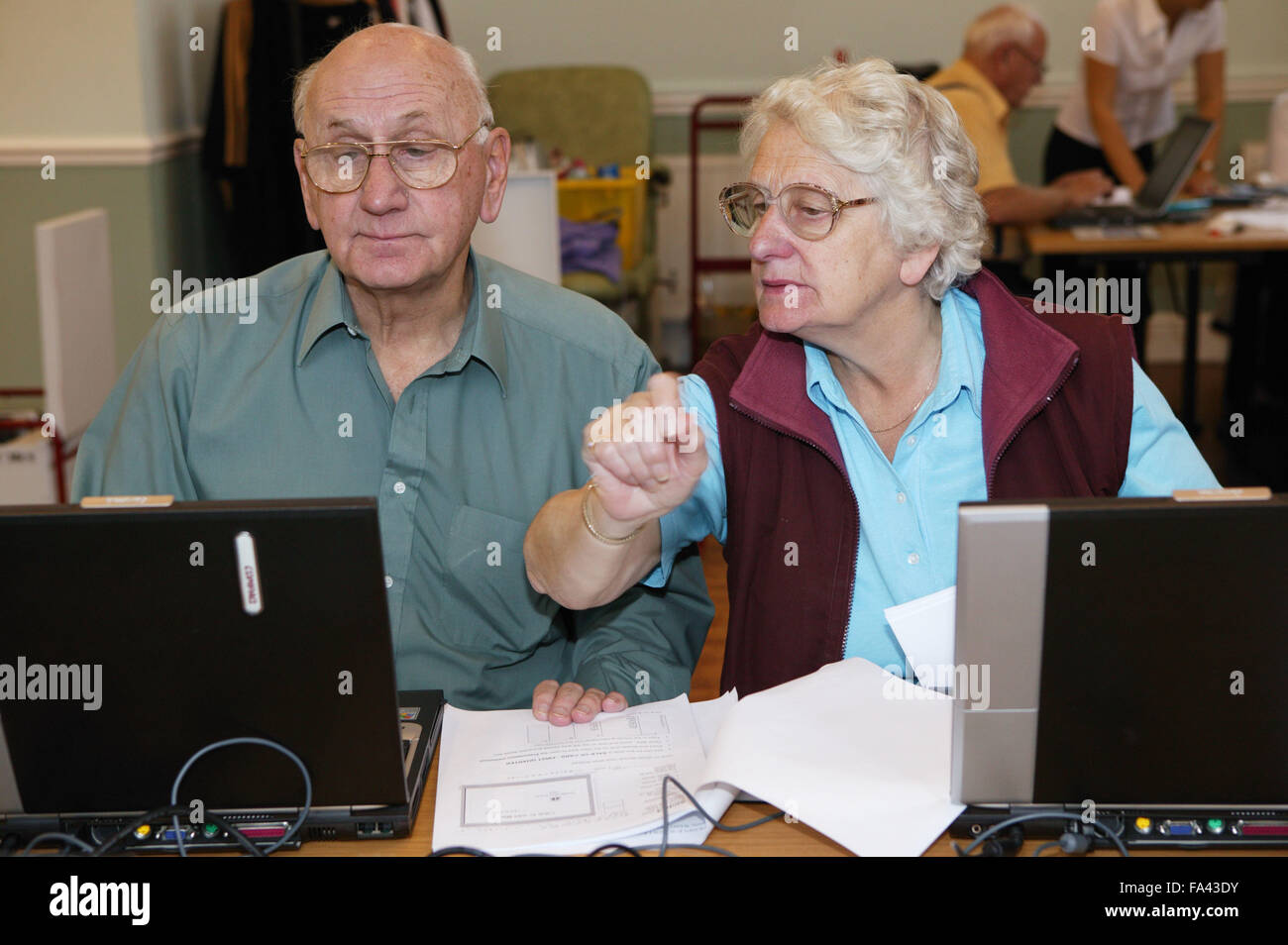 Man and woman at an over 60s computer training class; the Sybil Levin ...