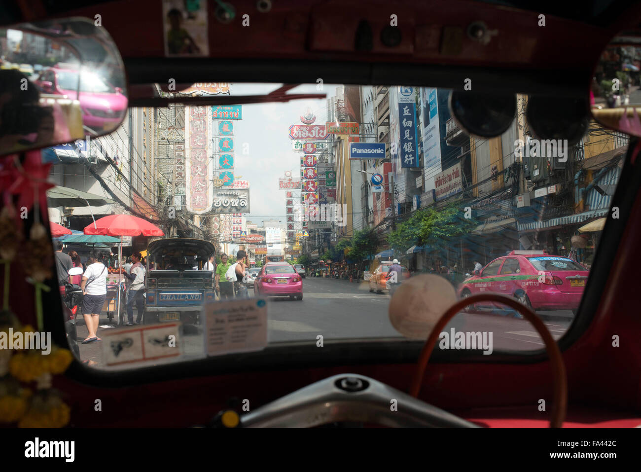Inside a Tuk tuks taxi in the street. View down Thanon Yaowarat road at night in central ...