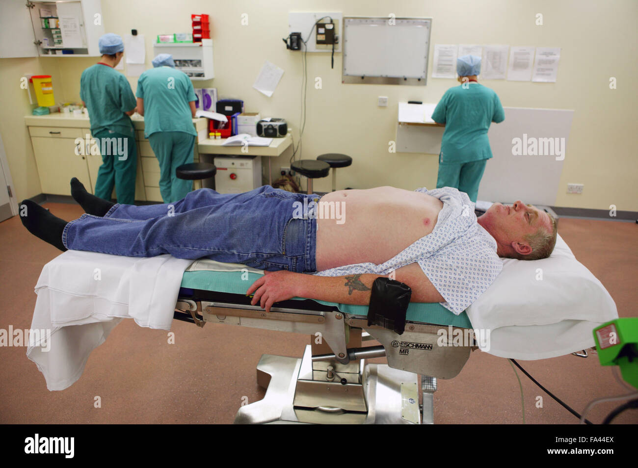 Patient lying on operating table waiting for anaesthetic to take effect ...