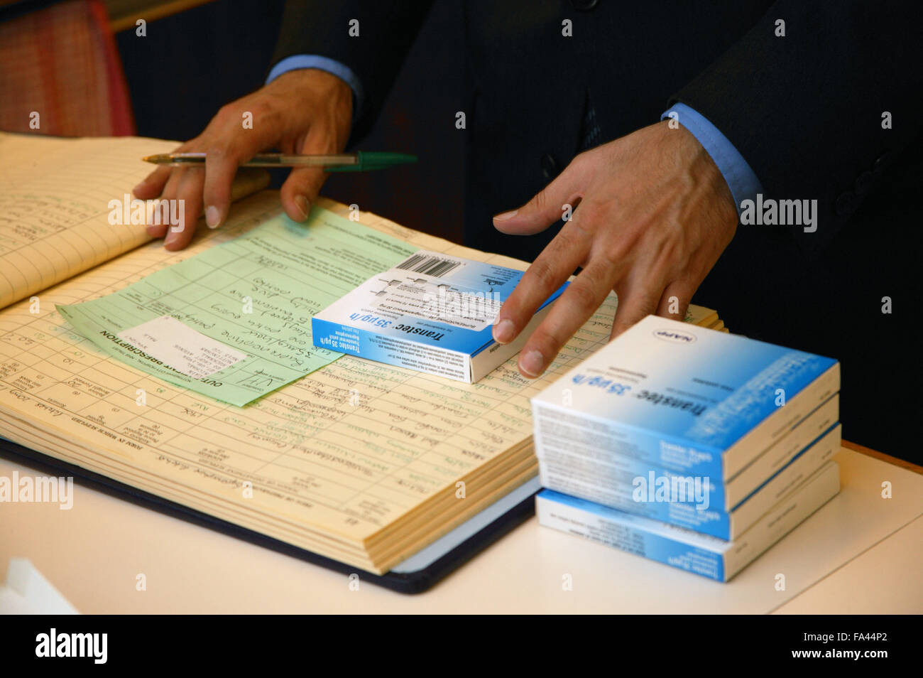 Pharmacist recording prepared outpatient prescription in the controlled ...