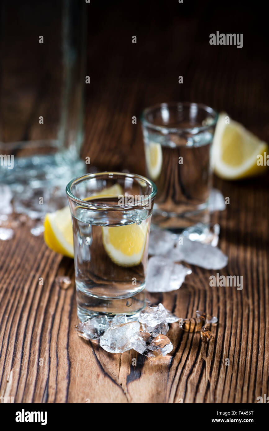 Shot of ice cold Vodka on rustic wooden background Stock Photo - Alamy