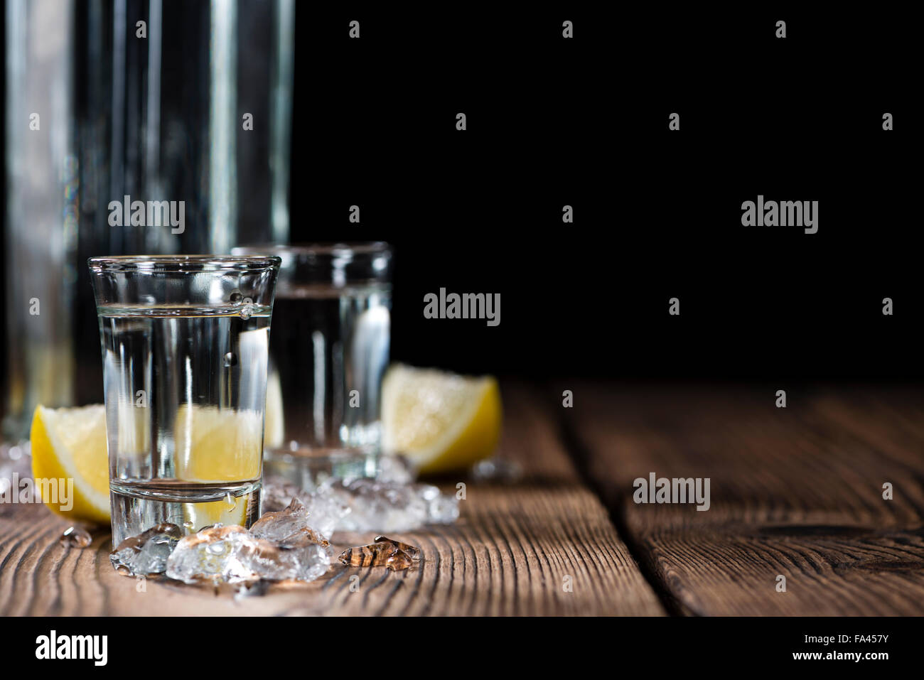 Shot of ice cold Vodka on rustic wooden background Stock Photo - Alamy