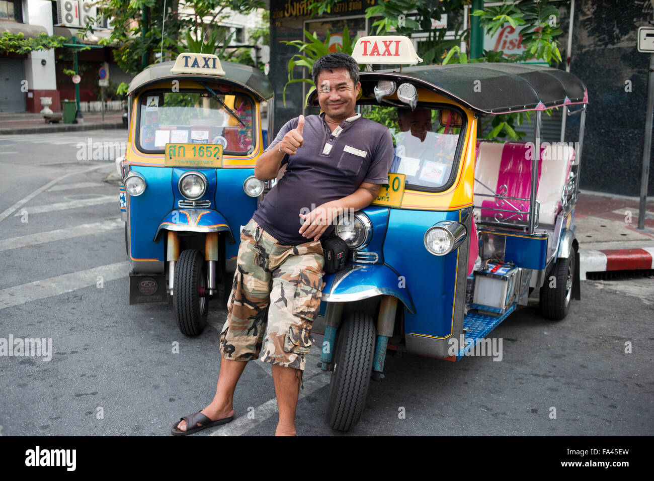 Tuk tuks taxi in the street. View down Thanon Yaowarat road at night in central Chinatown ...