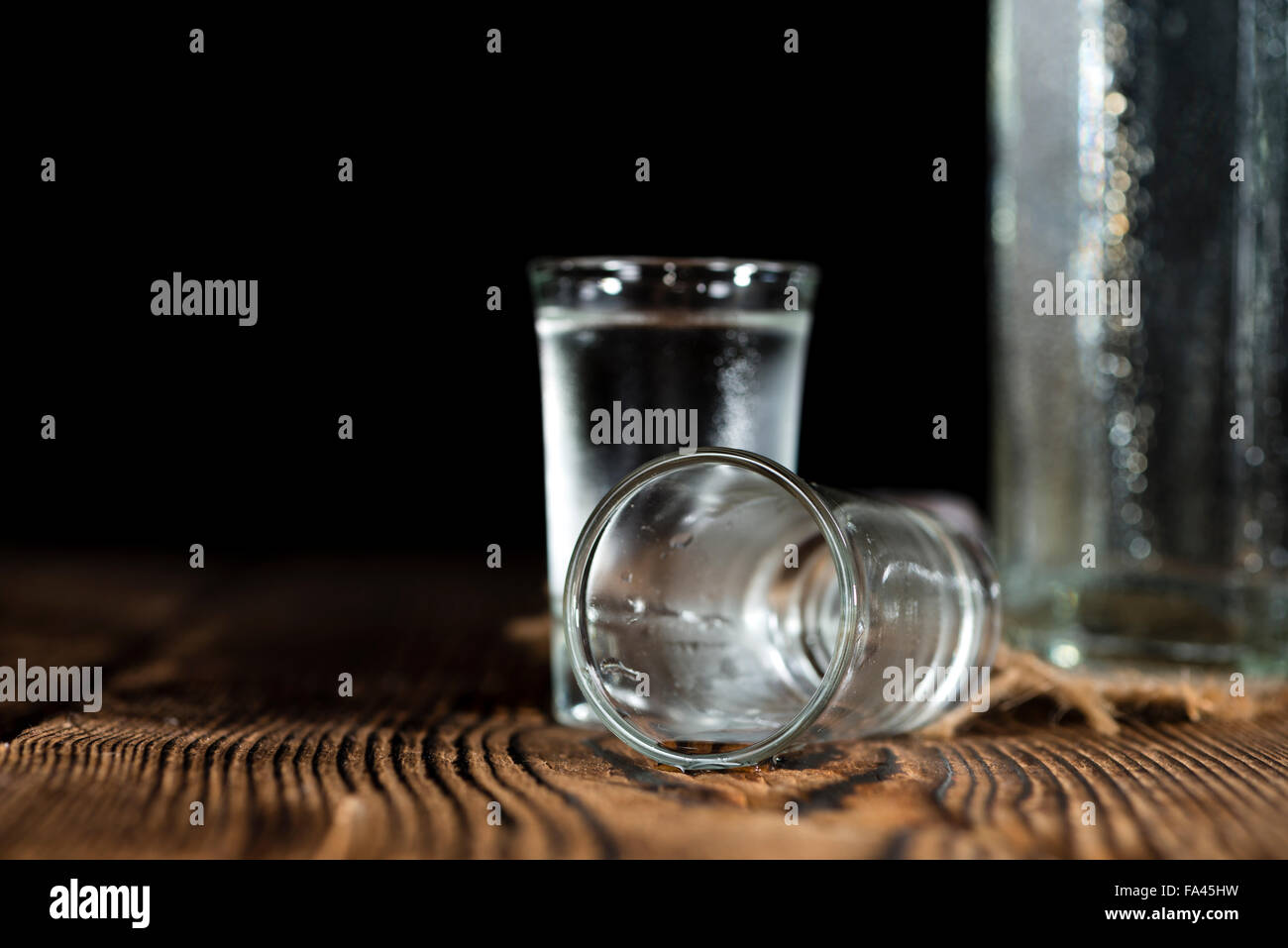 Shot of ice cold Vodka on rustic wooden background Stock Photo - Alamy