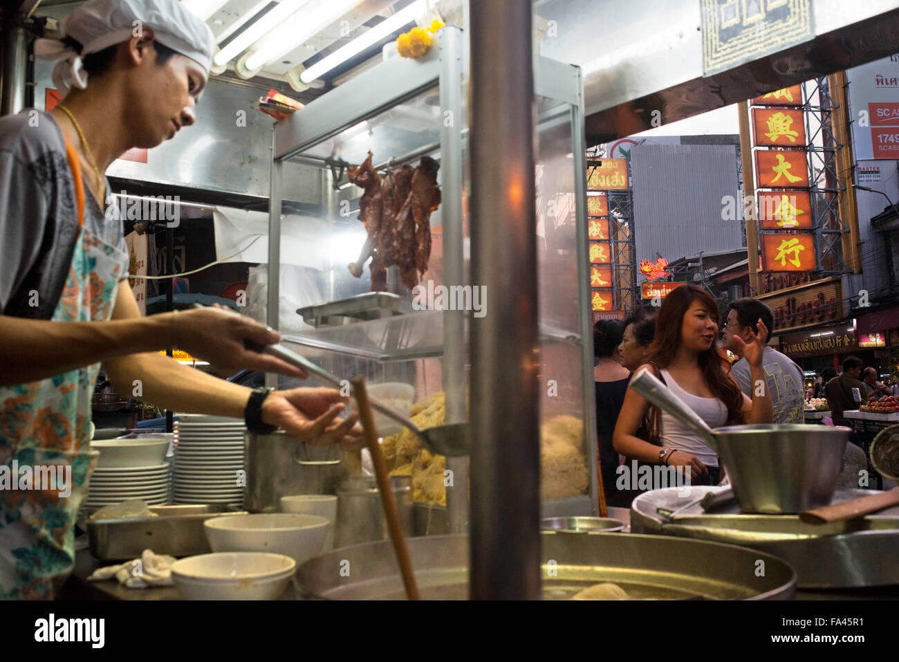 Woman selling pring rolls and durian fruits. Bangkok's Chinatown ...