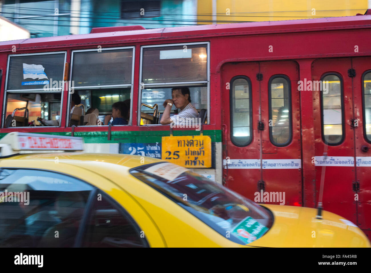 Public bus and taxi in the street. View down Thanon Yaowarat road at night in central Chinatown ...