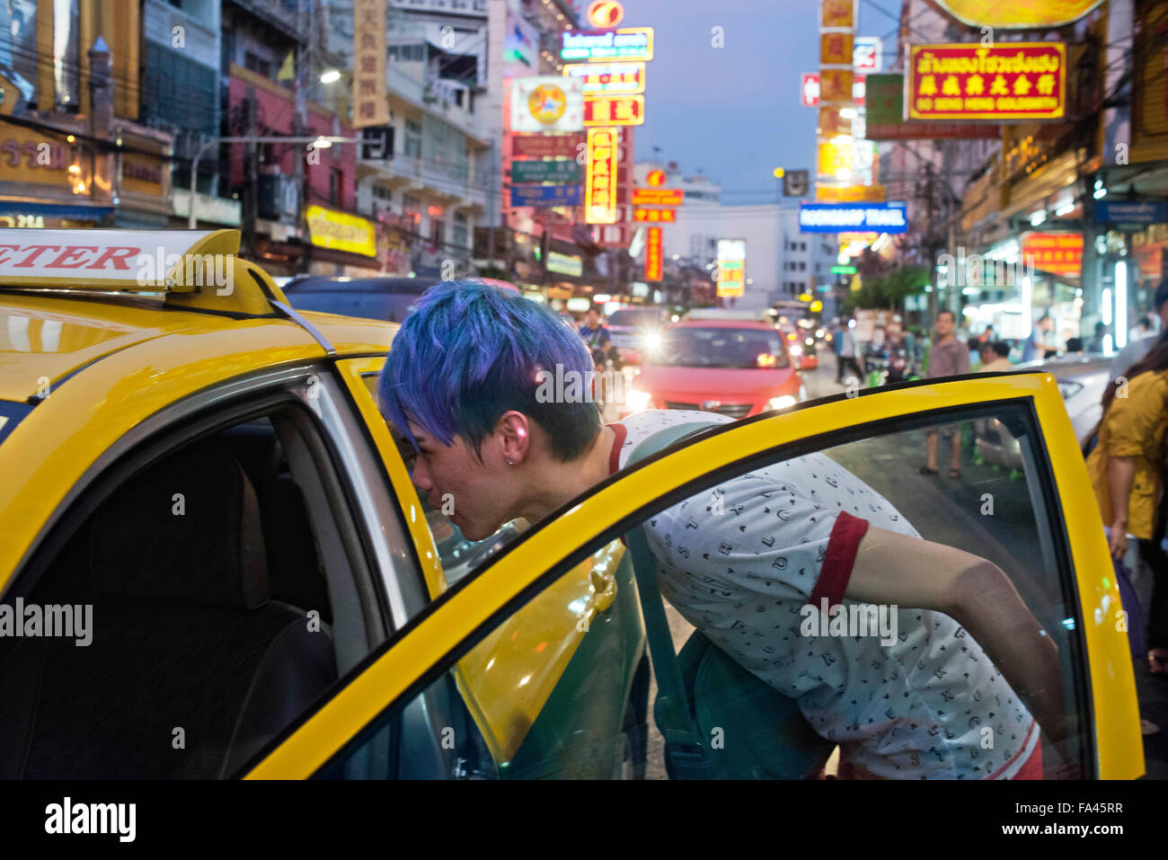 Taxi in the street. View down Thanon Yaowarat road at night in central Chinatown district of ...