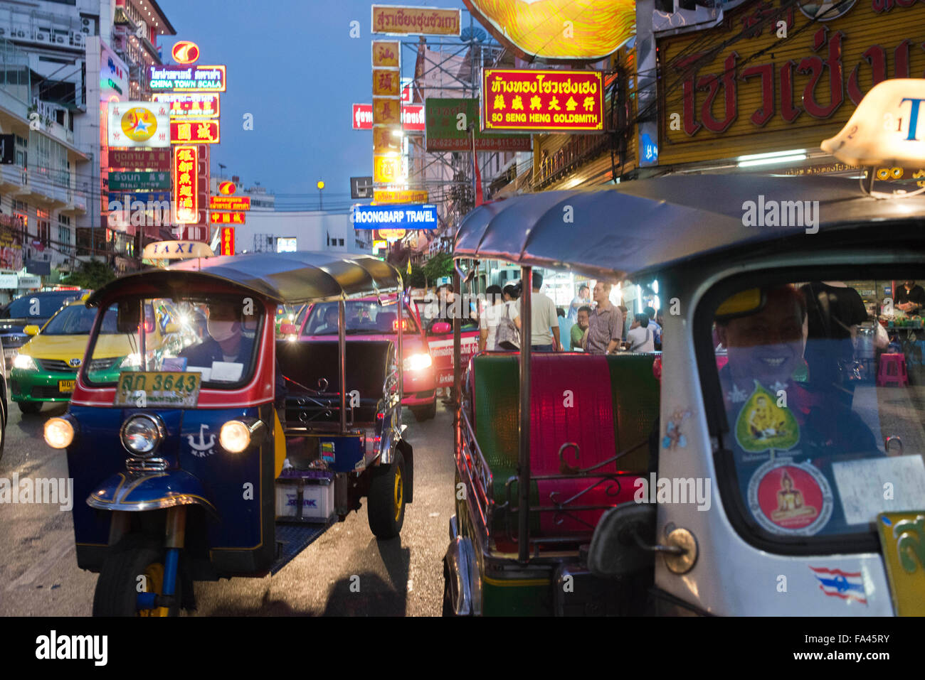 Tuk tuks taxi in the street. View down Thanon Yaowarat road at night in central Chinatown ...