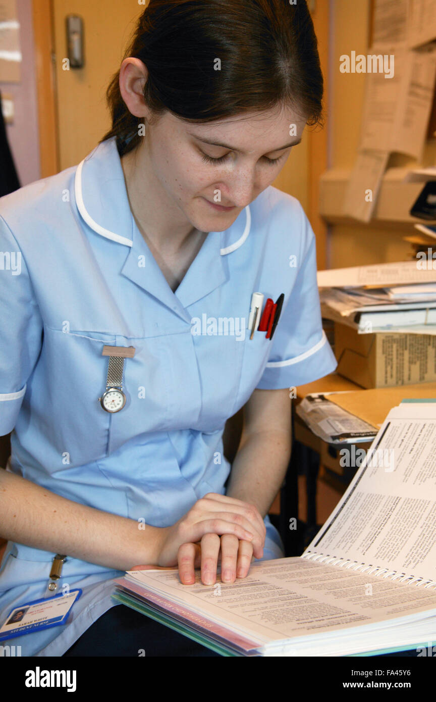 Student Nurse reading up on nursing procedures Stock Photo - Alamy