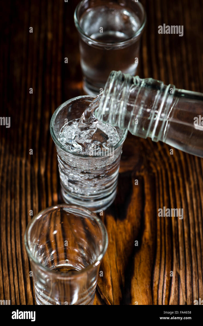 Shot of ice cold Vodka on rustic wooden background Stock Photo - Alamy