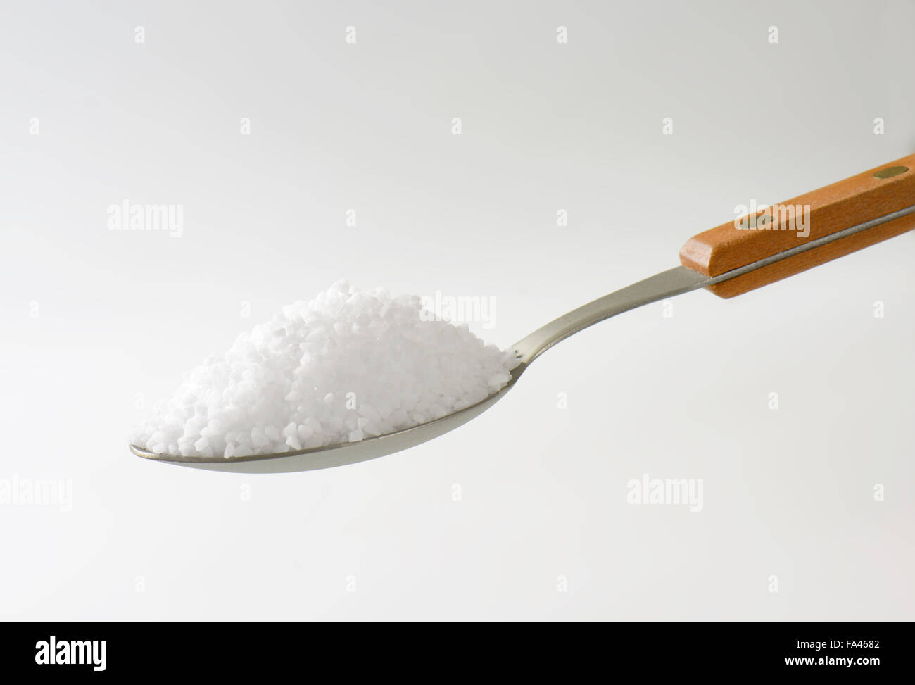 Spoonful of coarse ground salt Stock Photo - Alamy