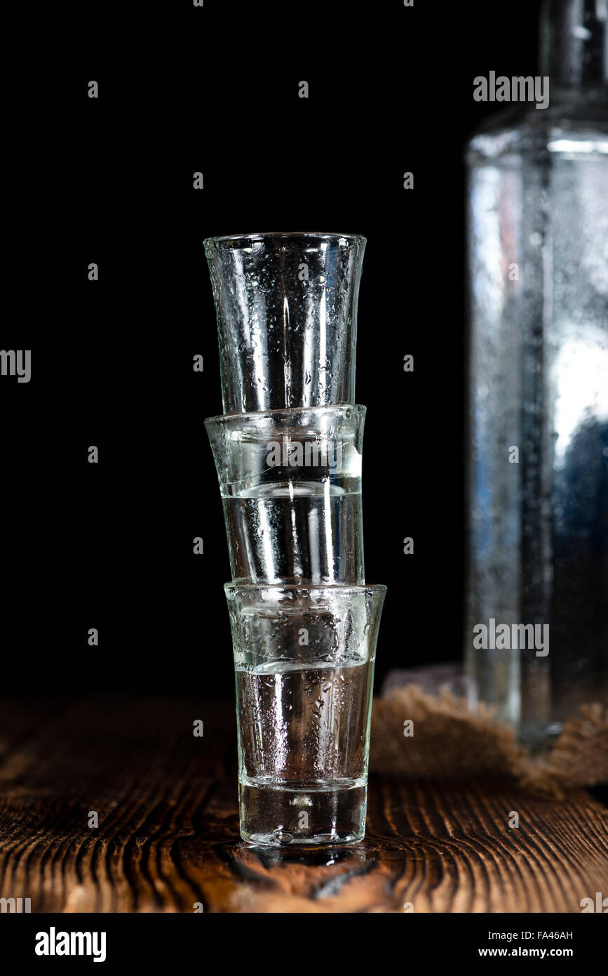 Pile of empty shot glasses (close-up shot) on wooden background Stock ...