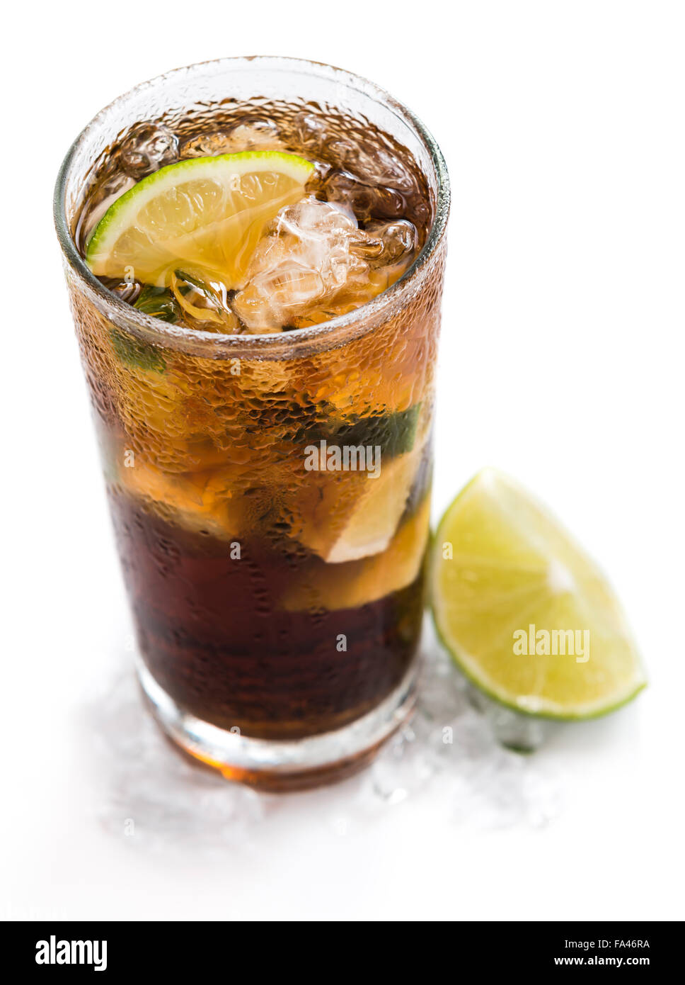 Cuba Libre Longdrink with brown rum and lime (isolated on white ...