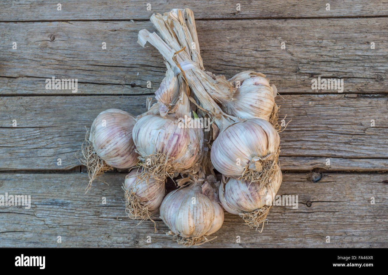 Bunch of garlic on a wooden background Stock Photo - Alamy