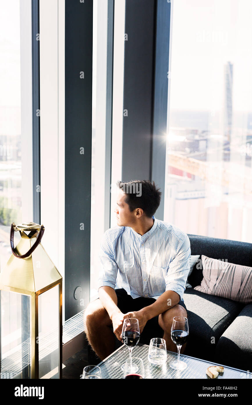 Sitting looking away contemplation wine glass food and drink hi-res ...