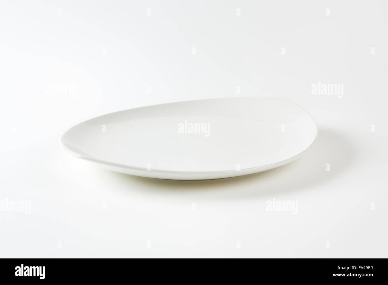 Oval white porcelain plate with pointed ends Stock Photo - Alamy